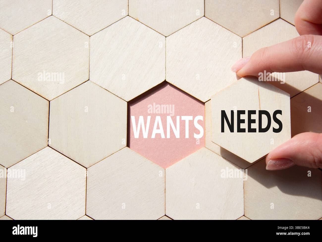 Wants and Needs symbol. Concept word Wants and Needs on wooden comb ...