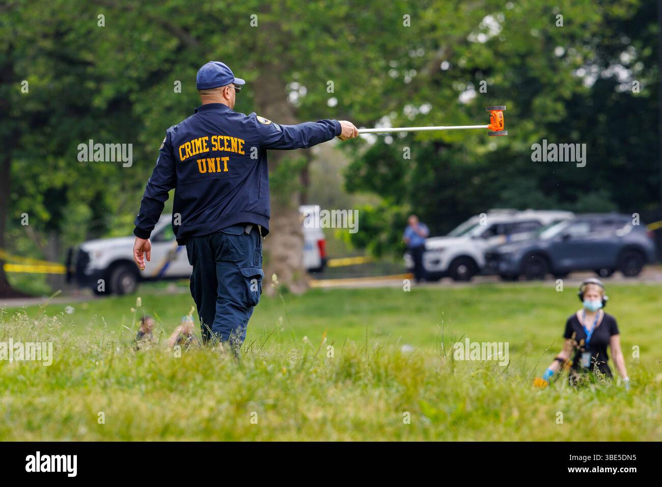 Philadelphia police Crime Scene Unit officer directs the search of ...