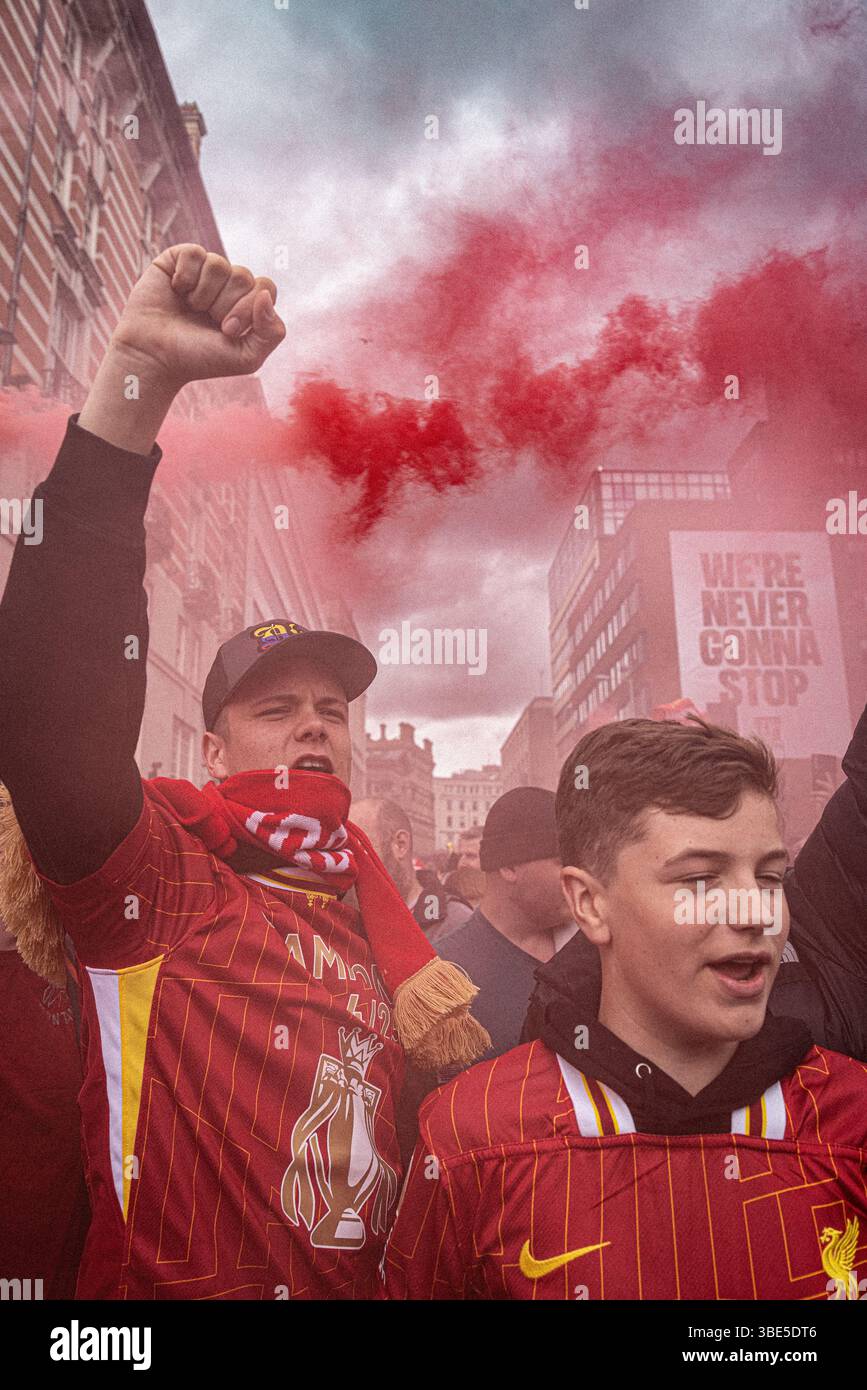 Liverpool fans celebrate with red flares as football players tour the ...