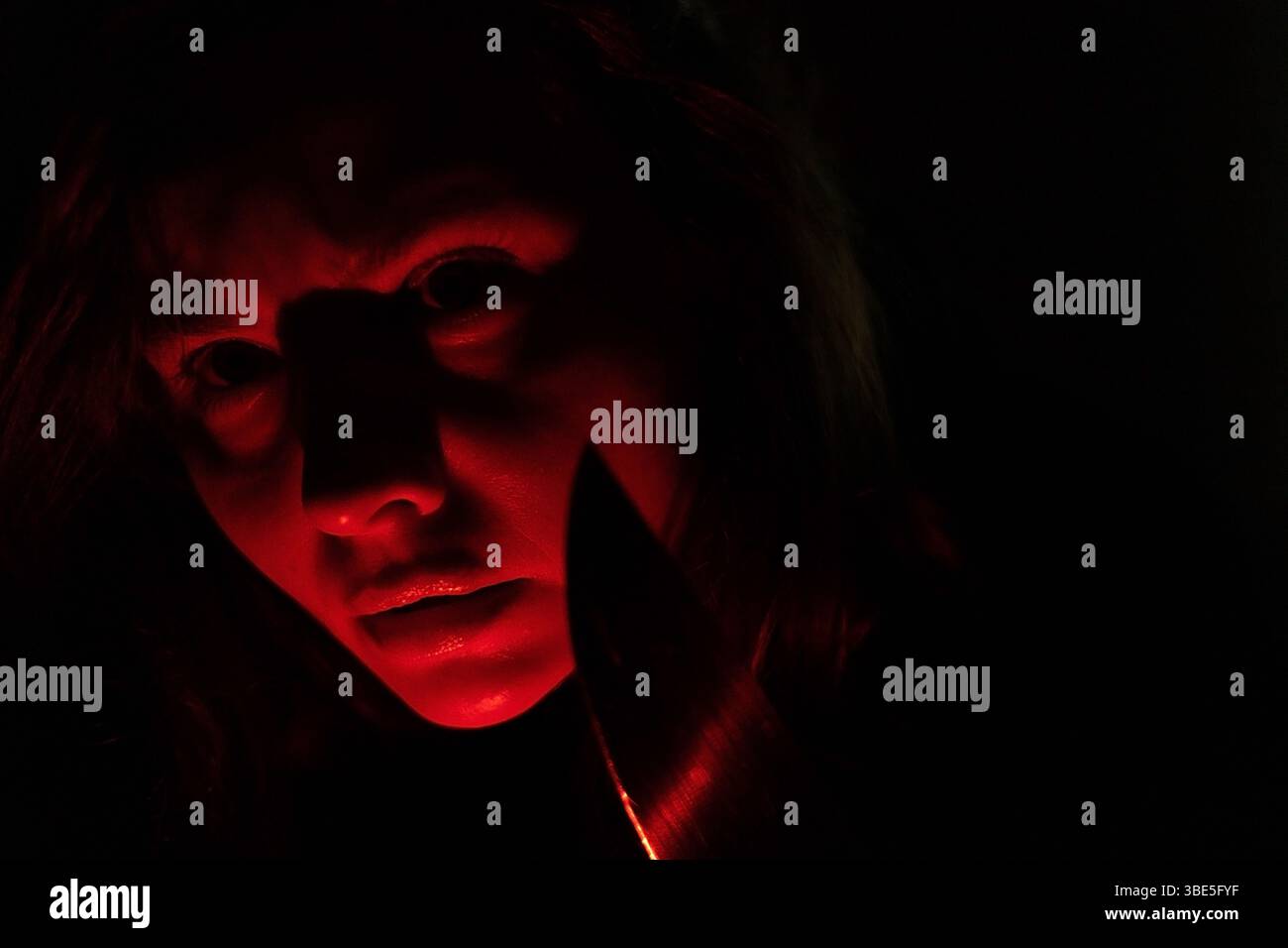 Creepy female portrait in red tones Stock Photo - Alamy