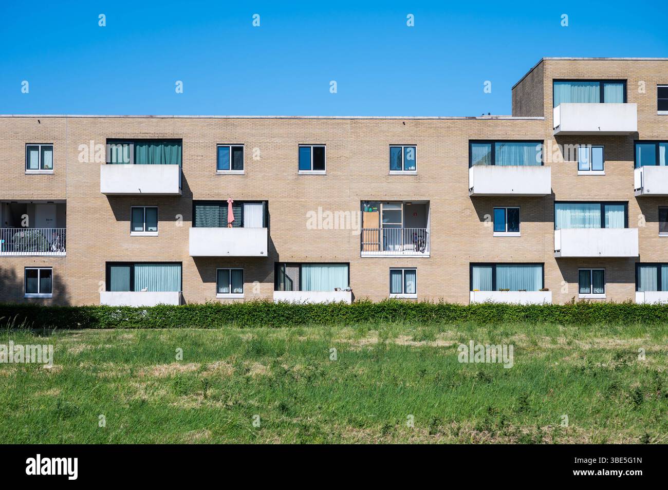 Modest apartment block and green meadow at the borders of the city of ...