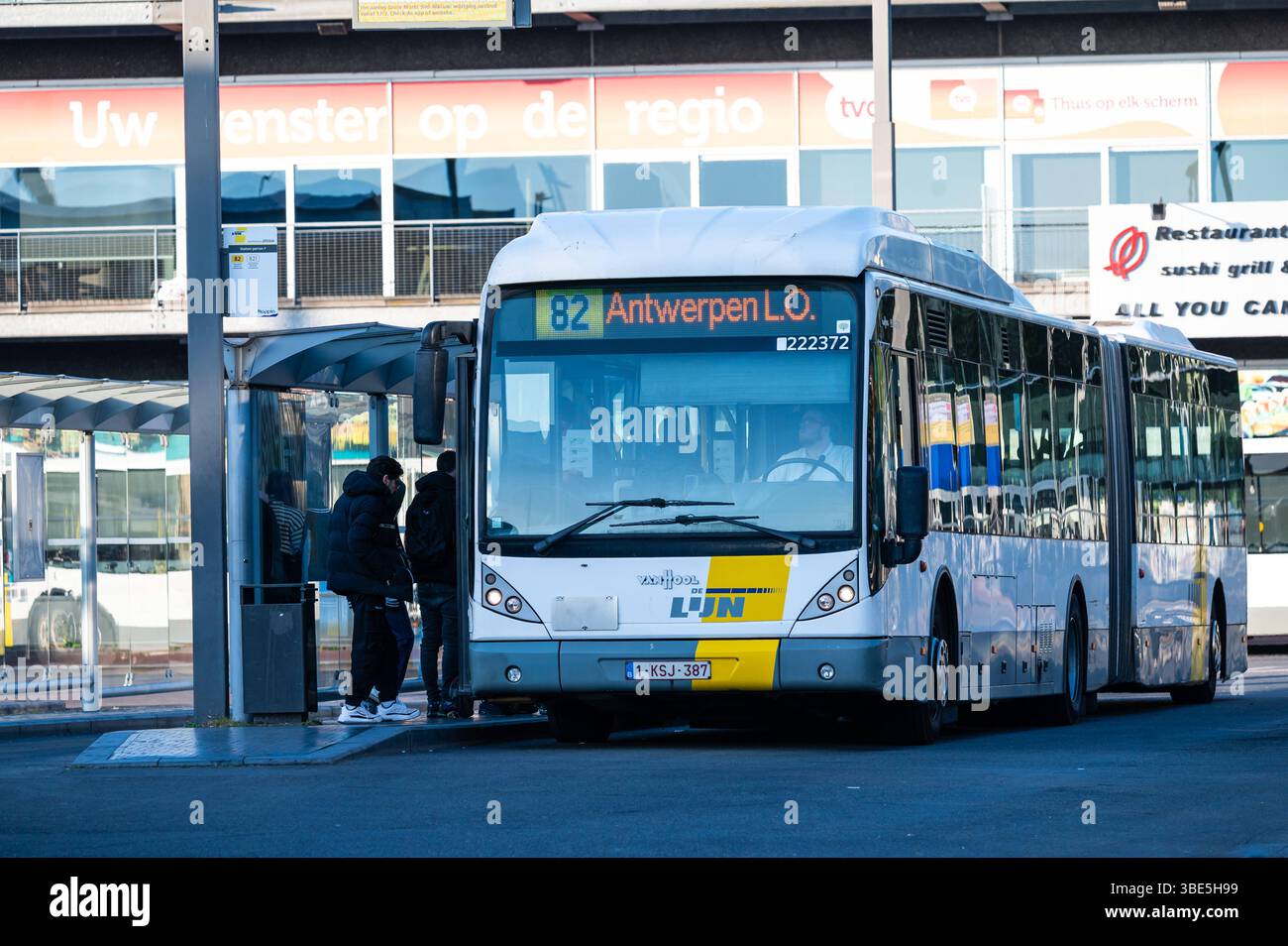 De Lijn bus at the railway station with passengers arriving in Sint ...