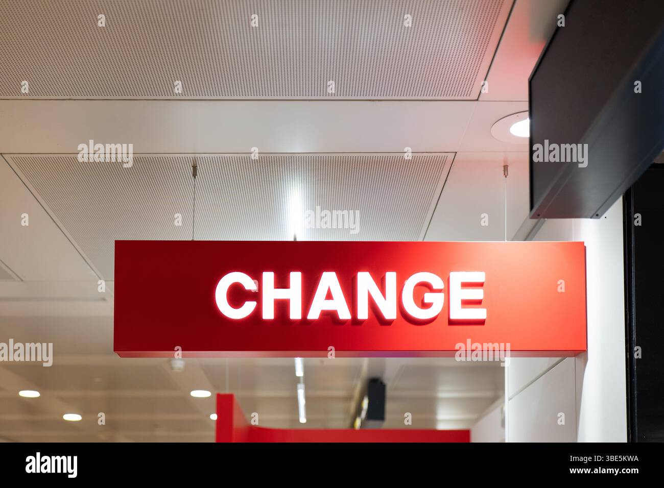 A red sign displaying the word CHANGE hangs from the ceiling of an ...