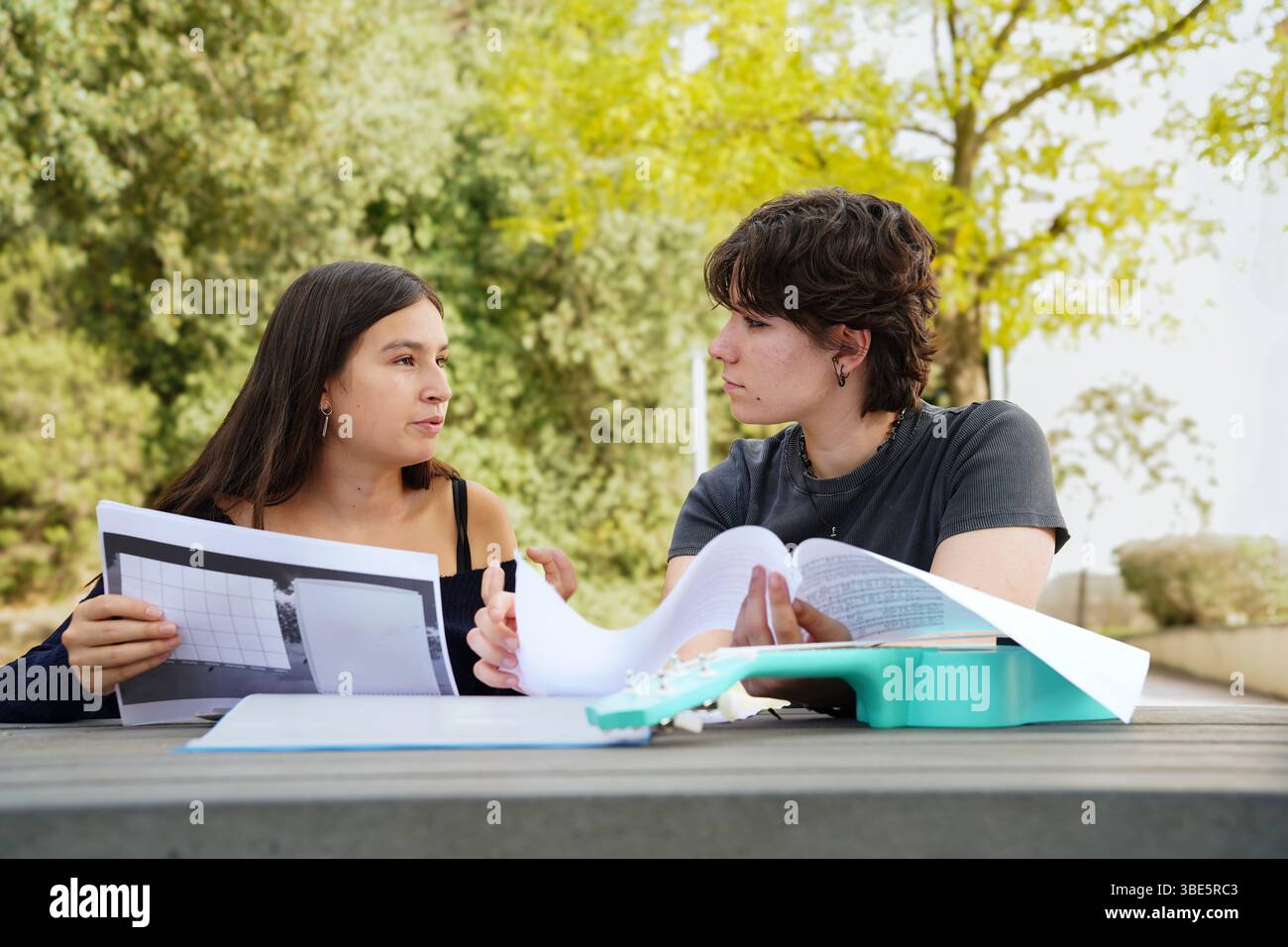 Two teenagers, a non-binary individual and a female, focus on school ...