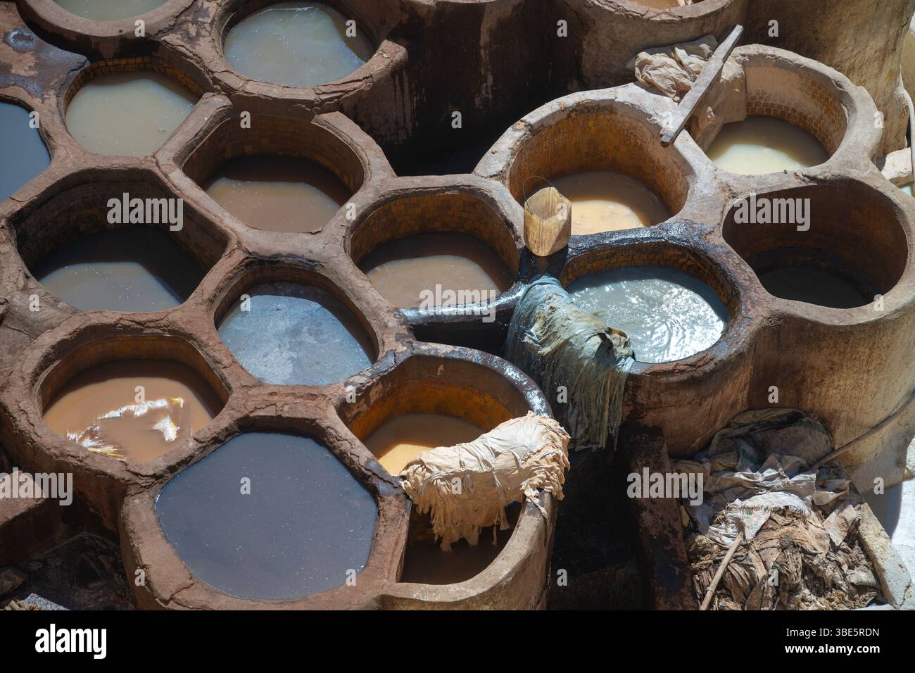 Aerial view of traditional leather tanning pits filled with vibrant dye ...