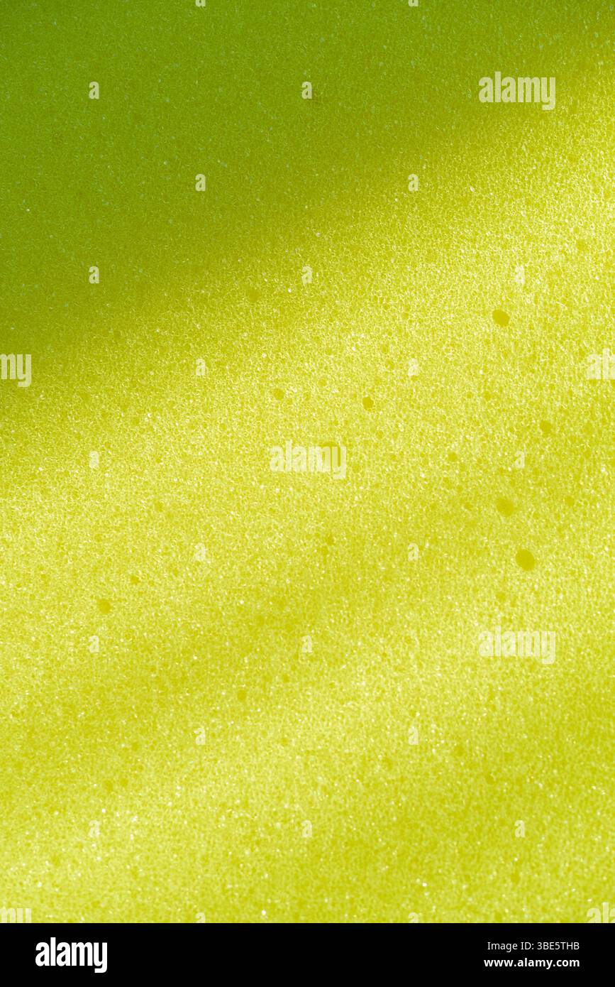 Background of porous foam rubber. Yellow foam rubber. Packaging ...