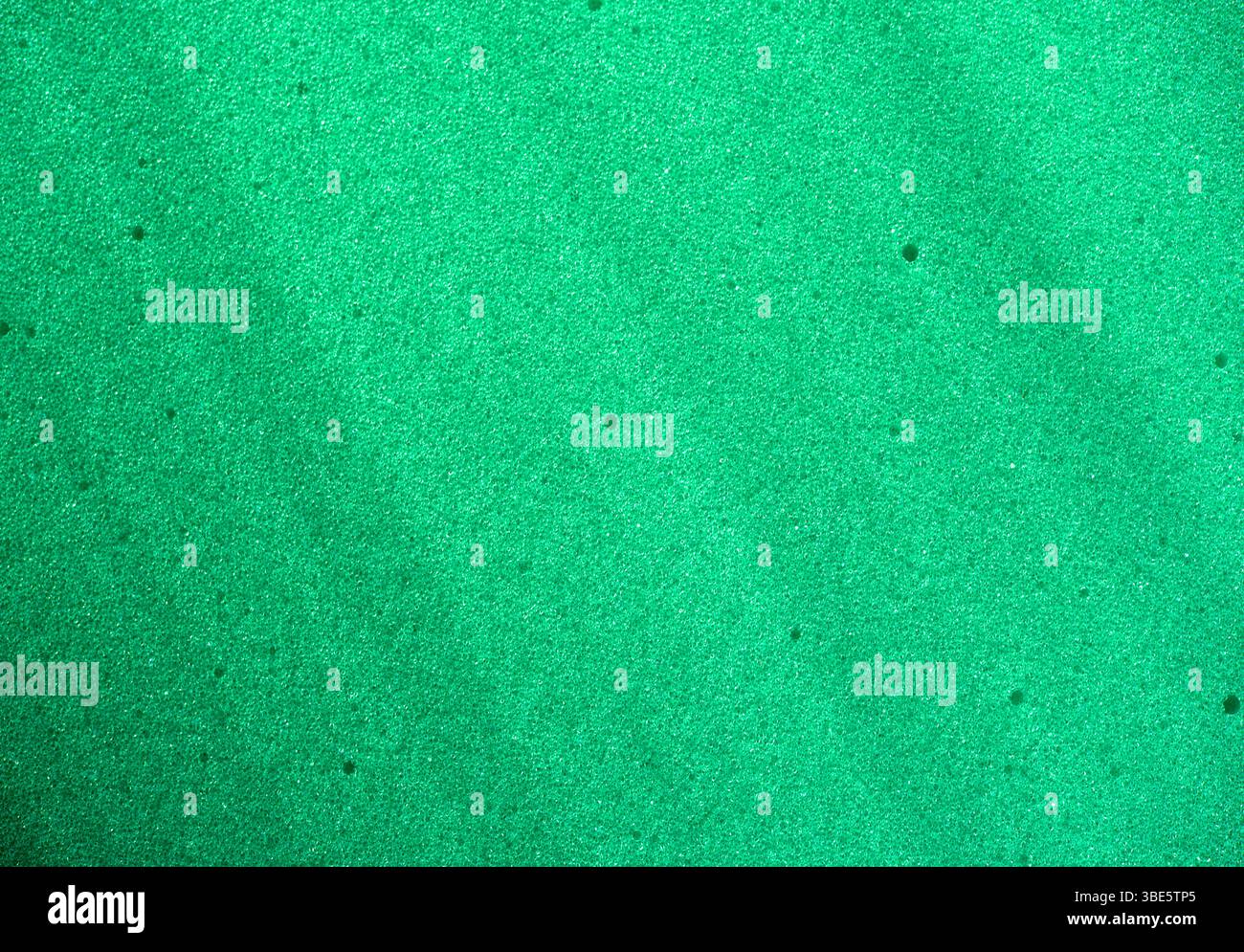 Background of porous foam rubber. Green foam rubber. Packaging material ...