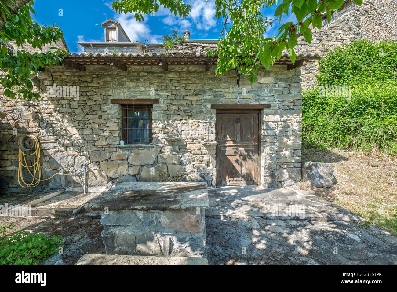 Rustic Stone Building Facade With Wooden Door And Window In A Rural ...