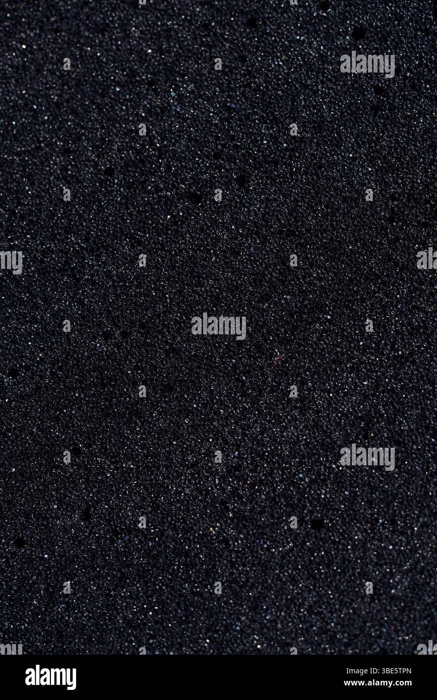 Background of porous foam rubber. Black foam rubber. Packaging material ...
