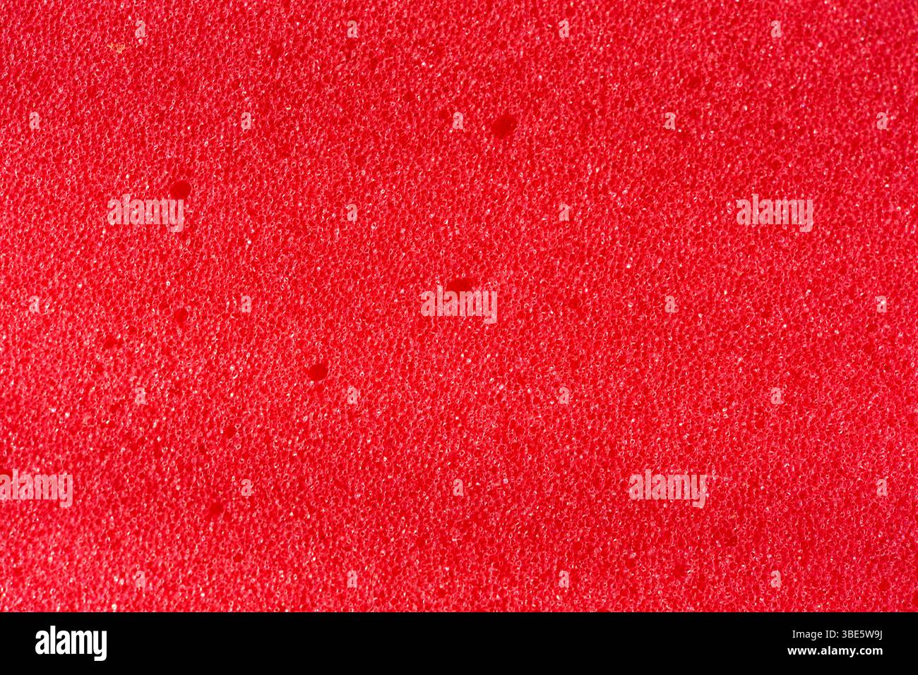 Background of porous foam rubber. Red foam rubber. Packaging material ...