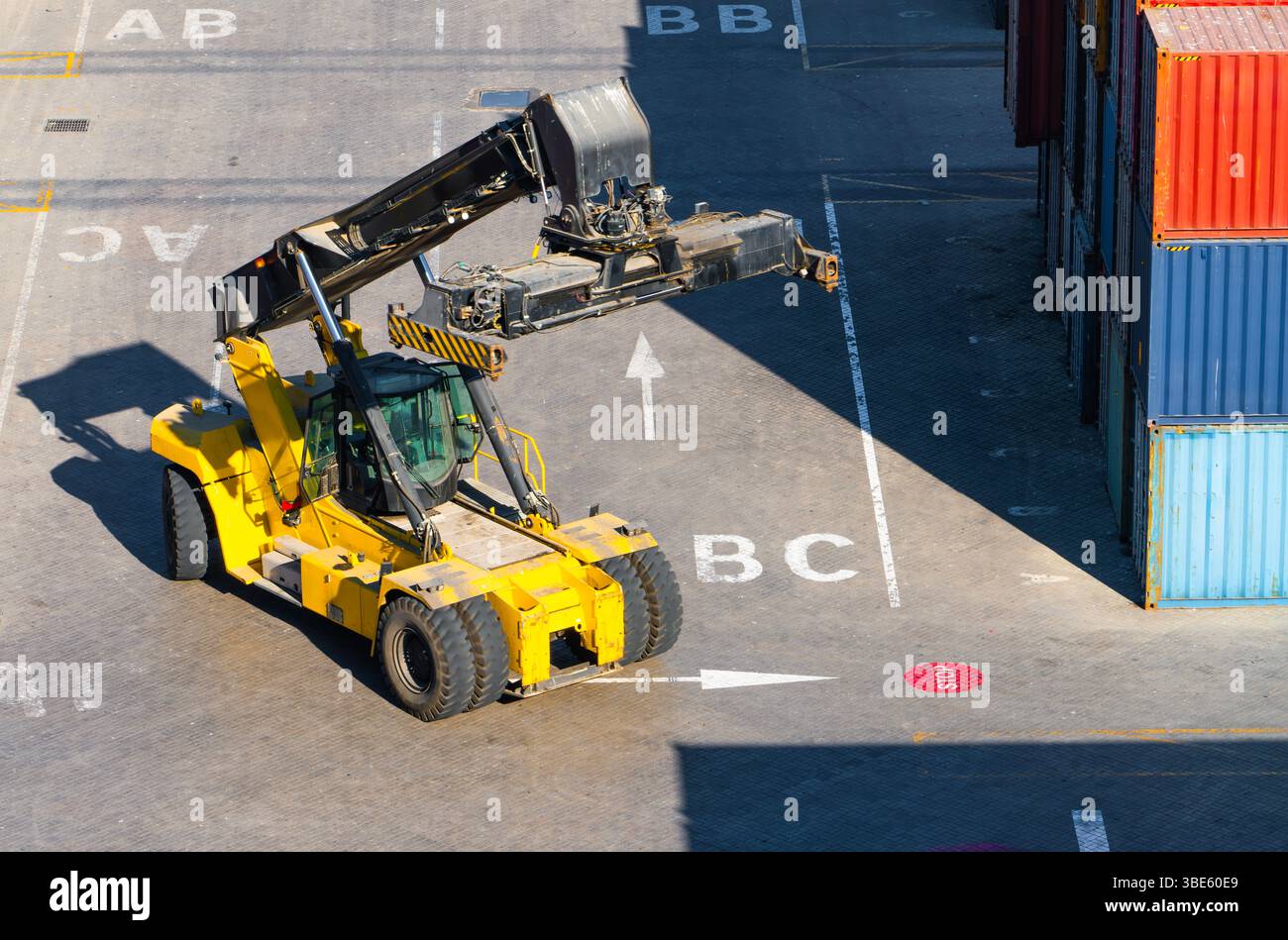 Yellow Reach Stacker Moving Between Shipping Containers in Cargo ...