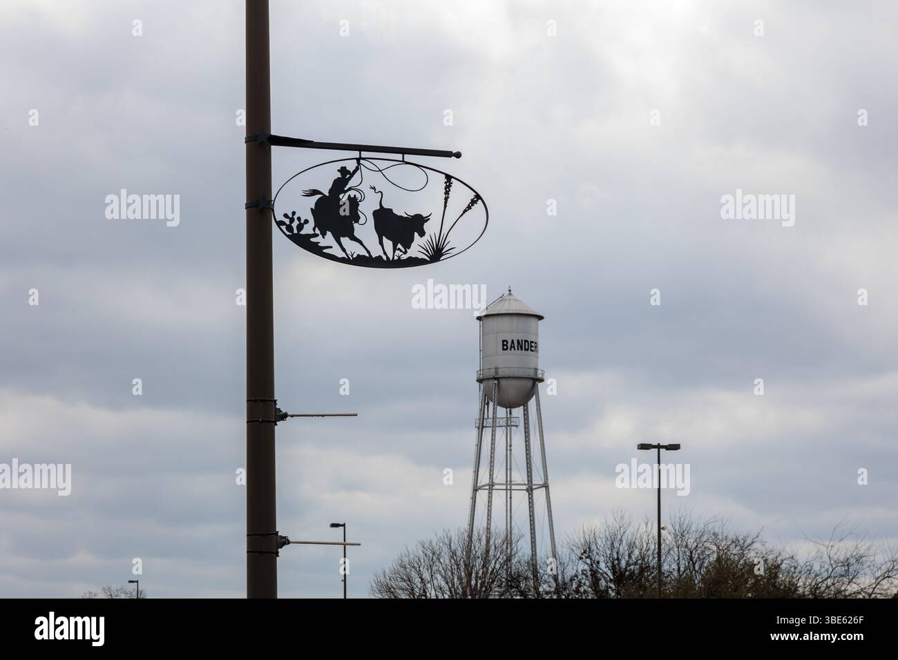 Bandera water tower behind artistic metal sign showing cowboy life on ...