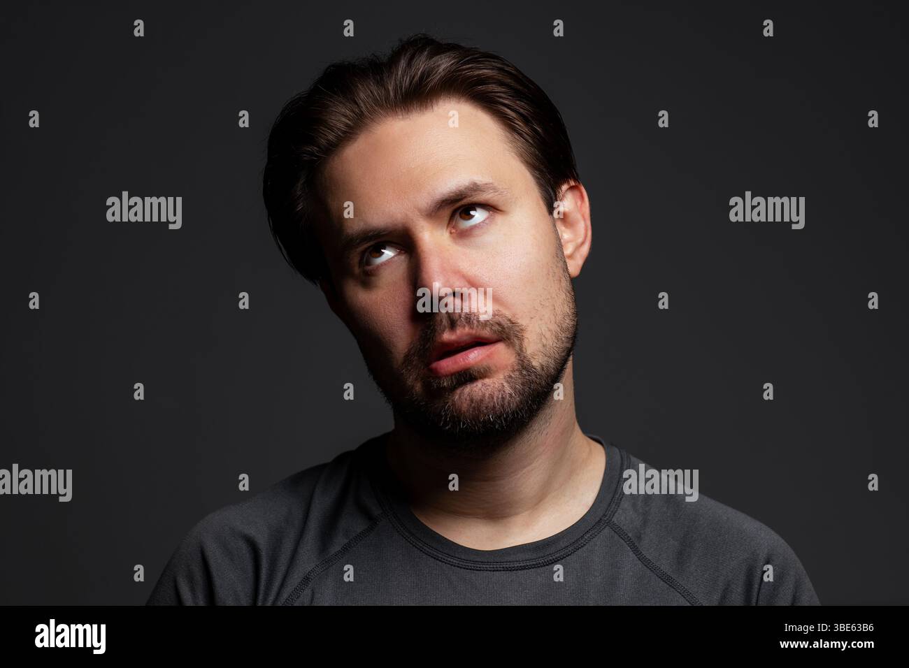 Young doubtful brunette man hi-res stock photography and images - Alamy