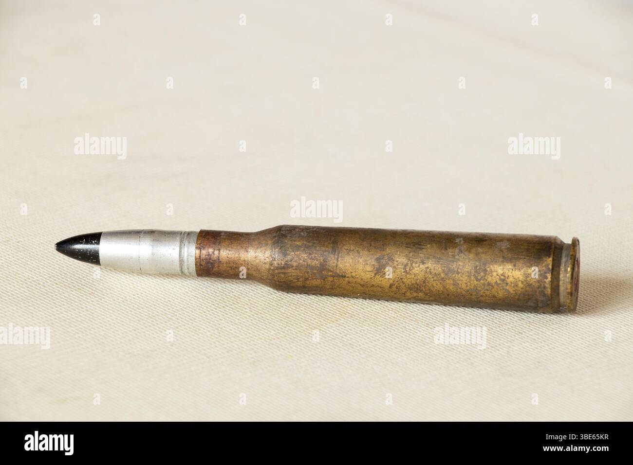 Single large caliber cartridge on light fabric, military theme Stock ...