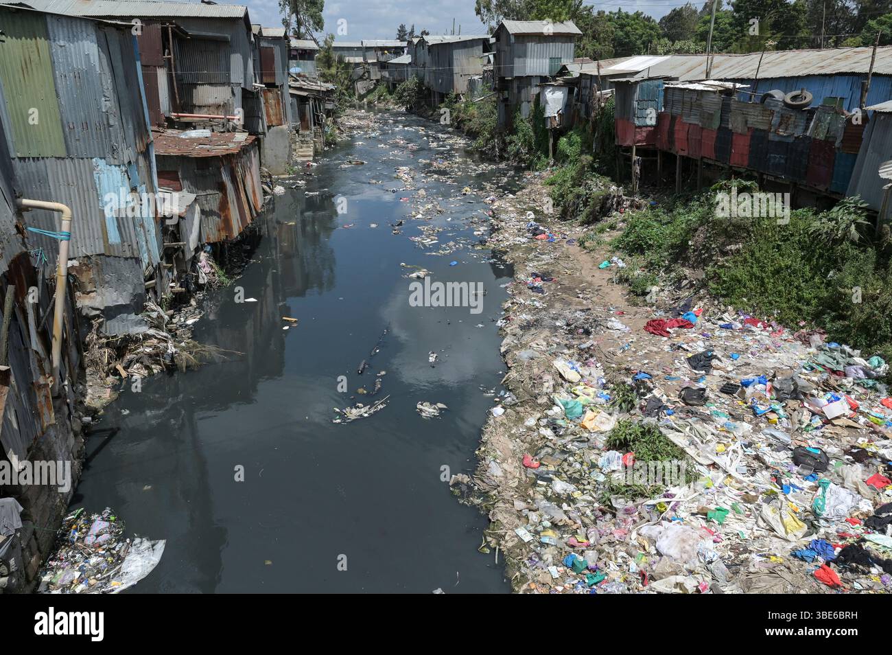 KENYA, Nairobi, slum Mukuru, polluted river with sewage and plastic ...