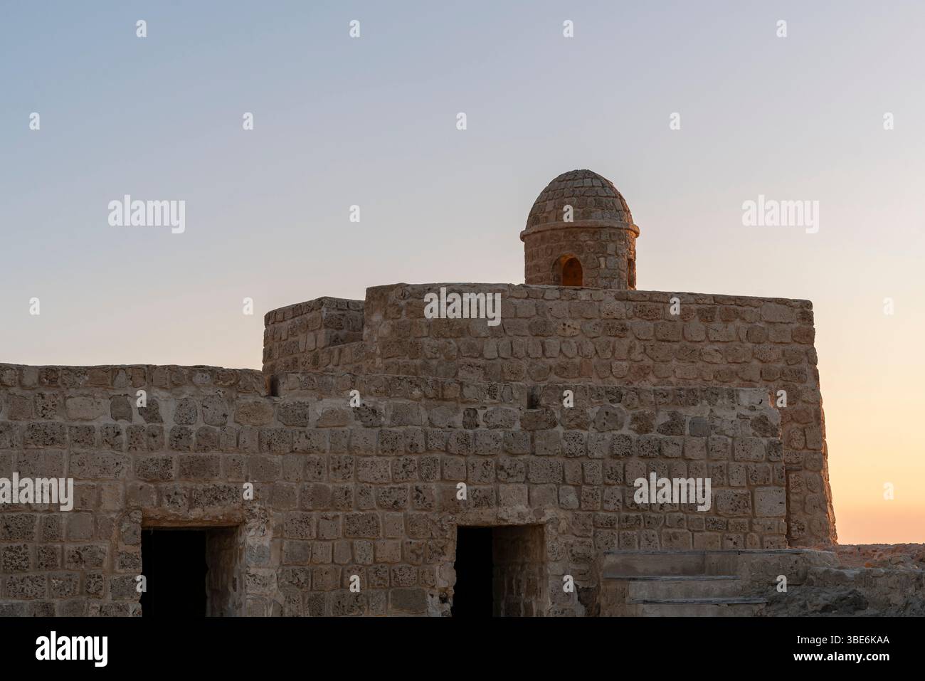 A domed turret rises above thick stone walls in Qalat al Bahrain as ...