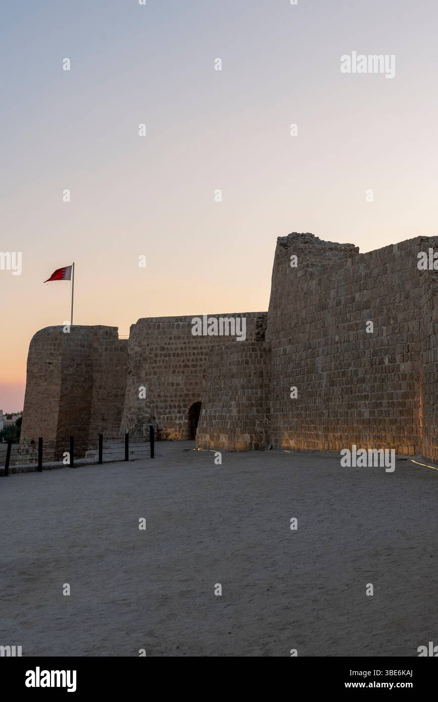 Fortified walls and domed turrets of Qalat al Bahrain Fort in Manama ...