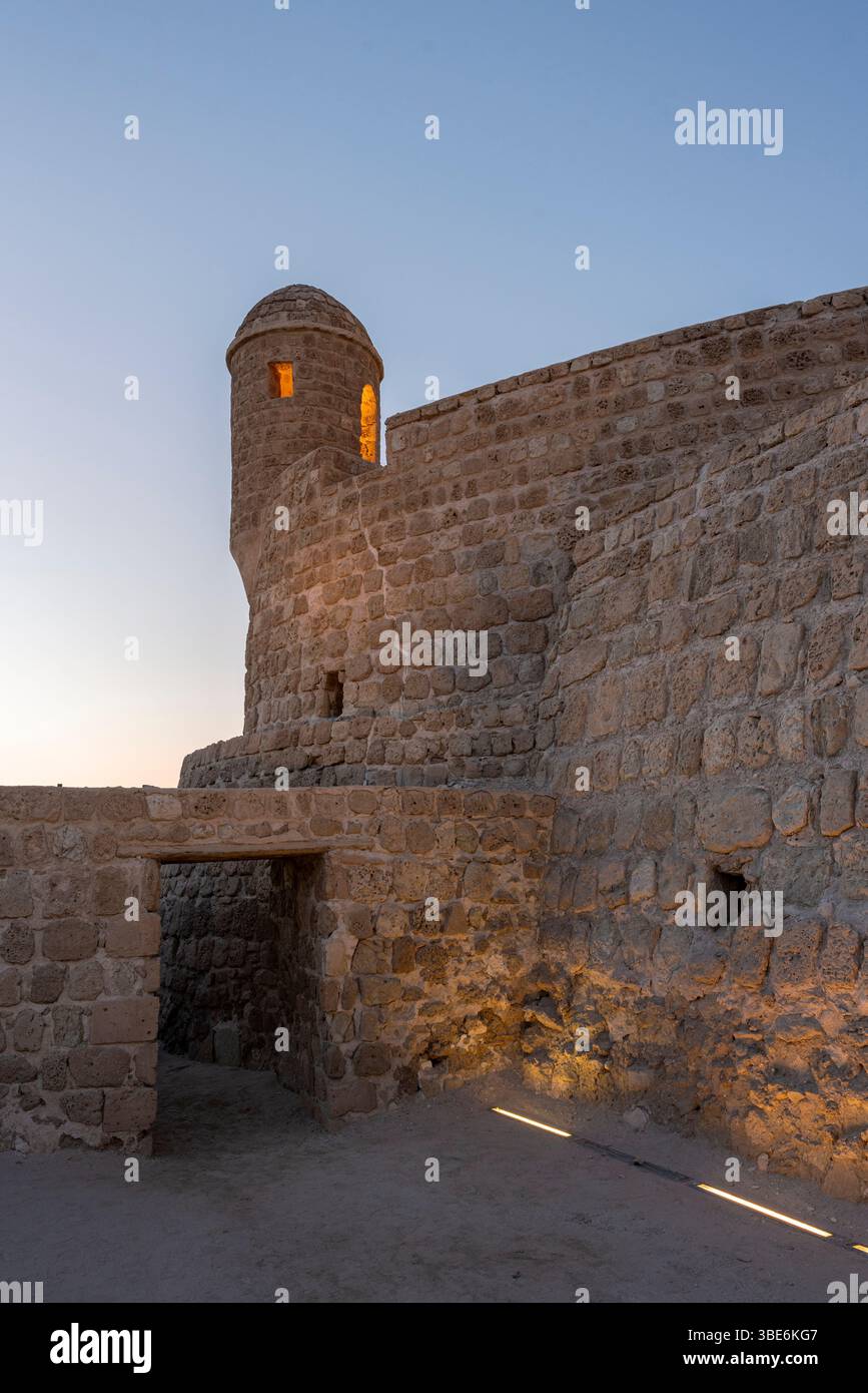 Tall stone turret and fortified wall capture golden evening light at ...