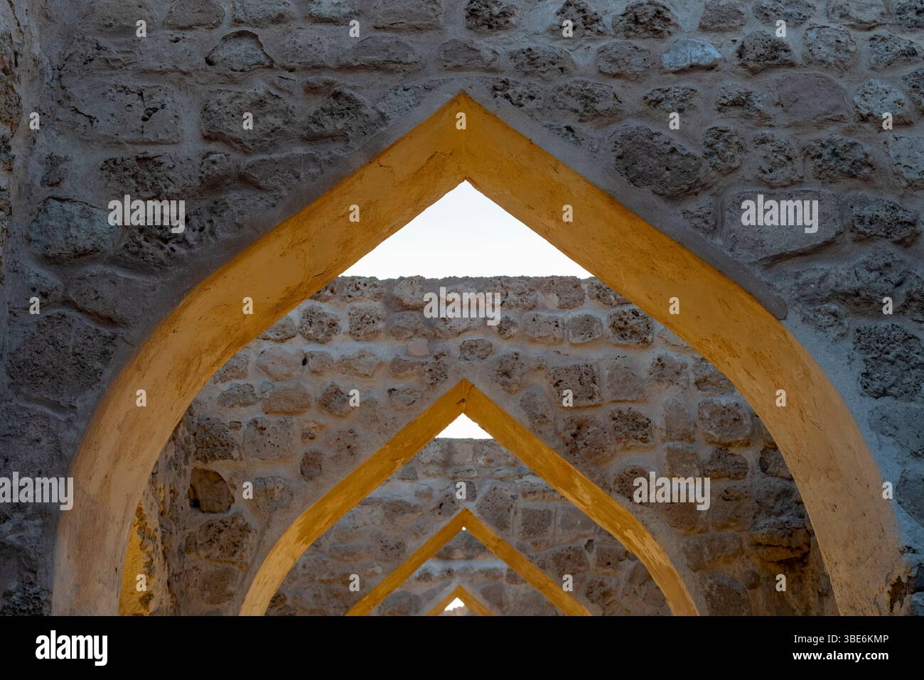 Stone archways in Qalat al Bahrain Fort in Manama form a perfect ...