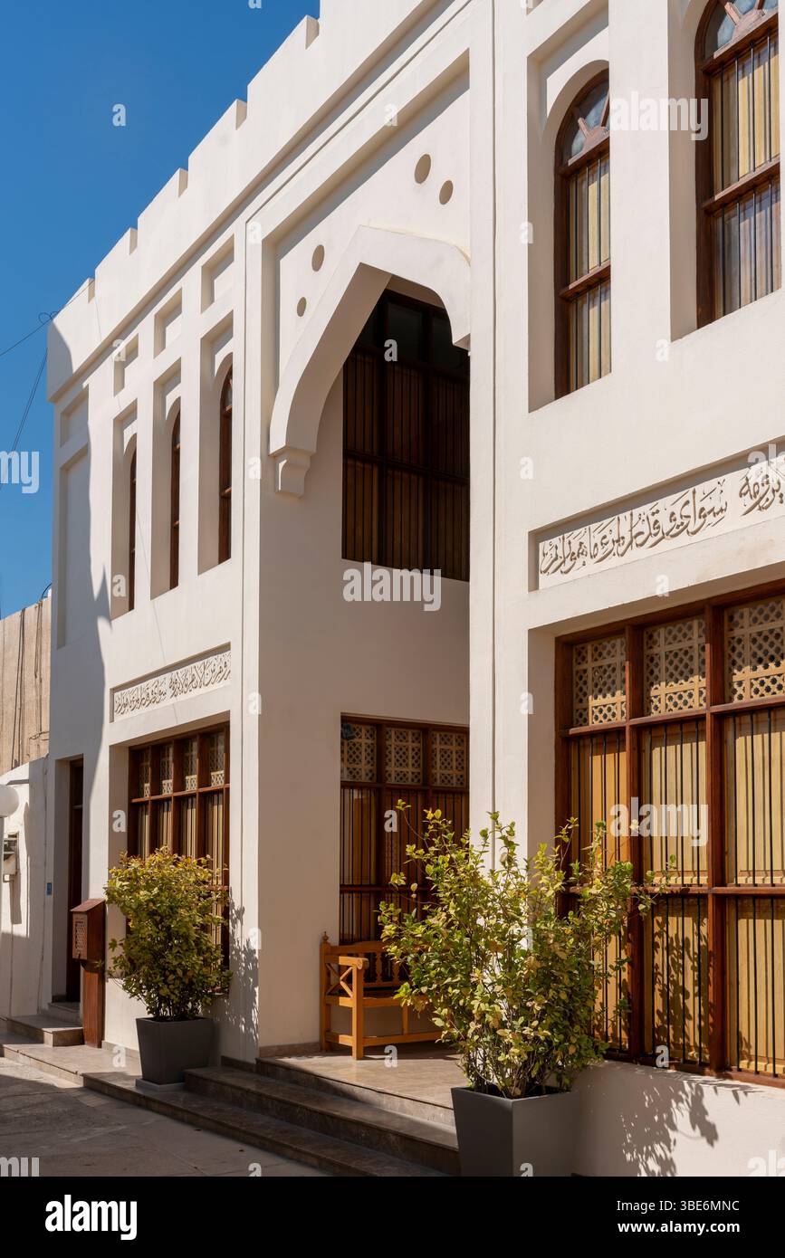 Traditional courtyard entrance with plants and white walls at Sheikh ...