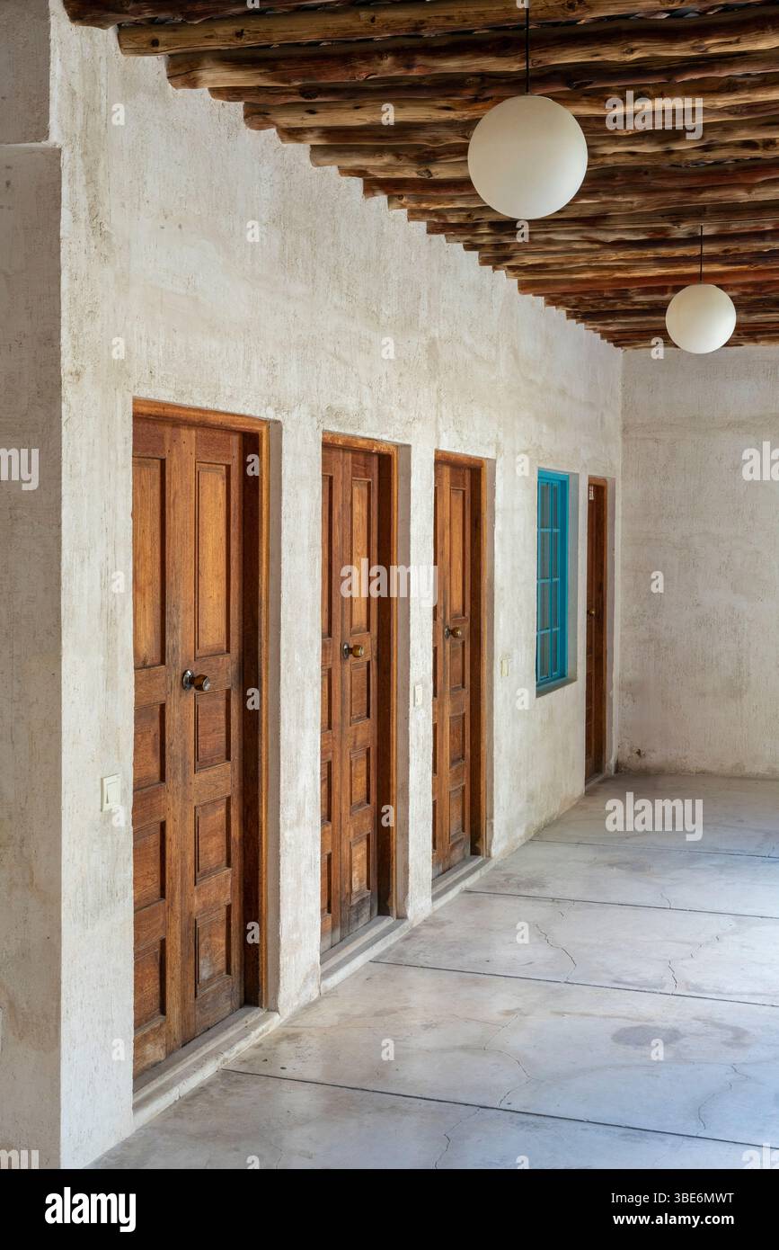 Traditional covered walkway with white columns and wooden ceiling ...