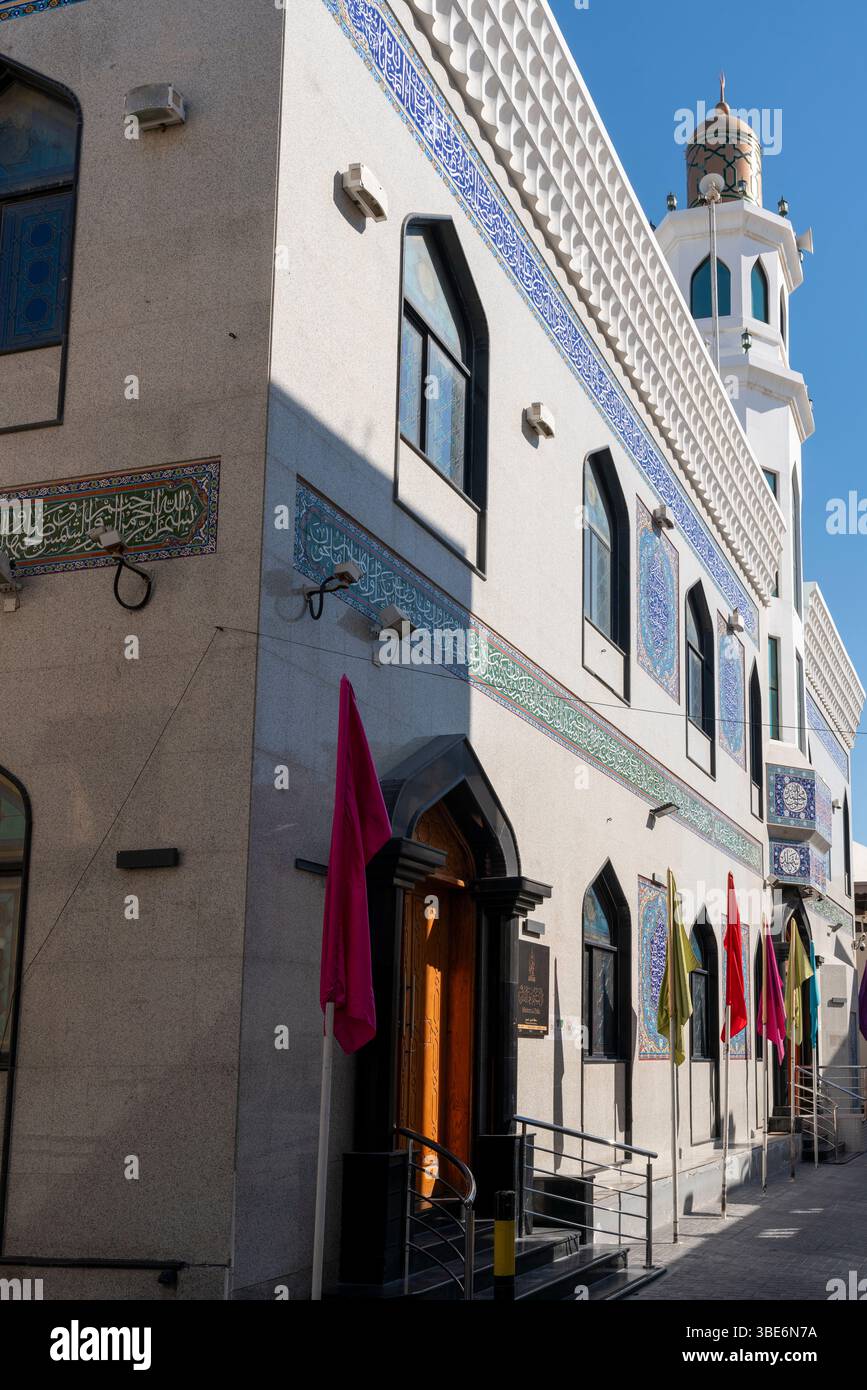 Traditional white mosque with ornate arched facade at Matam Al Hala on the Pearling Path in ...