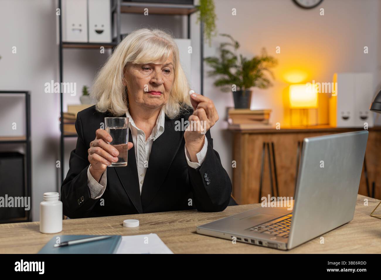Sick upset senior businesswoman grandmother working on laptop computer ...