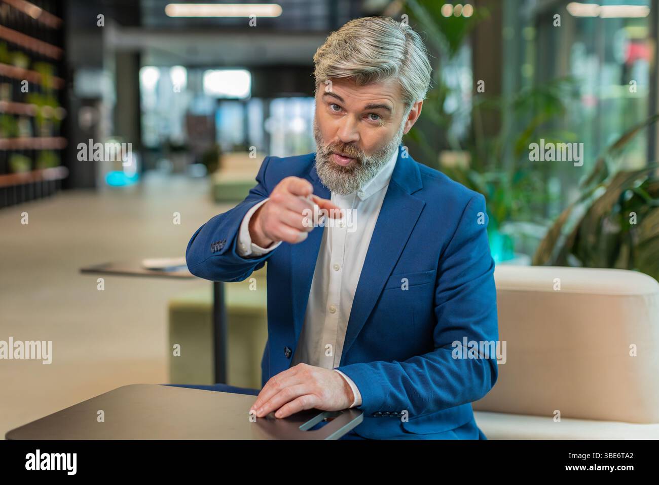I choose you. Caucasian middle-aged businessman pointing to camera ...