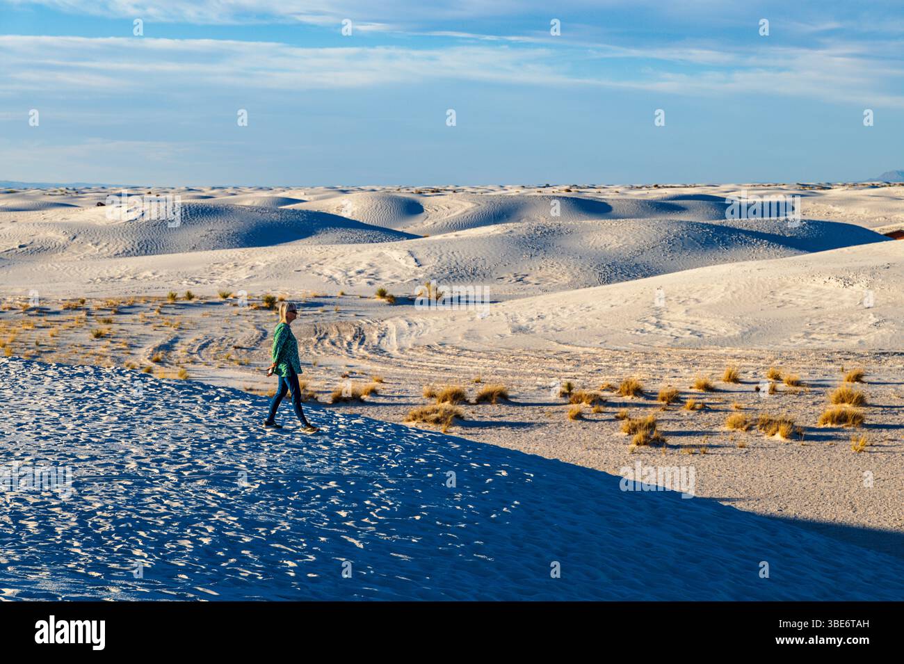 Adult female hiking sand dunes at White Sands National Park; New Mexico ...