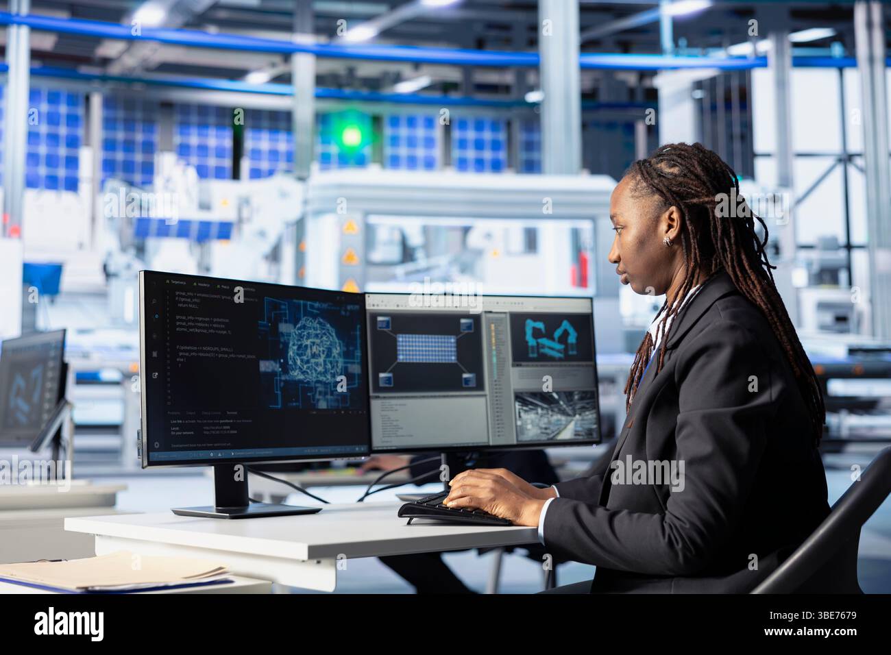 Engineer coding in solar panel plant, using artificial intelligence to automate equipment ...