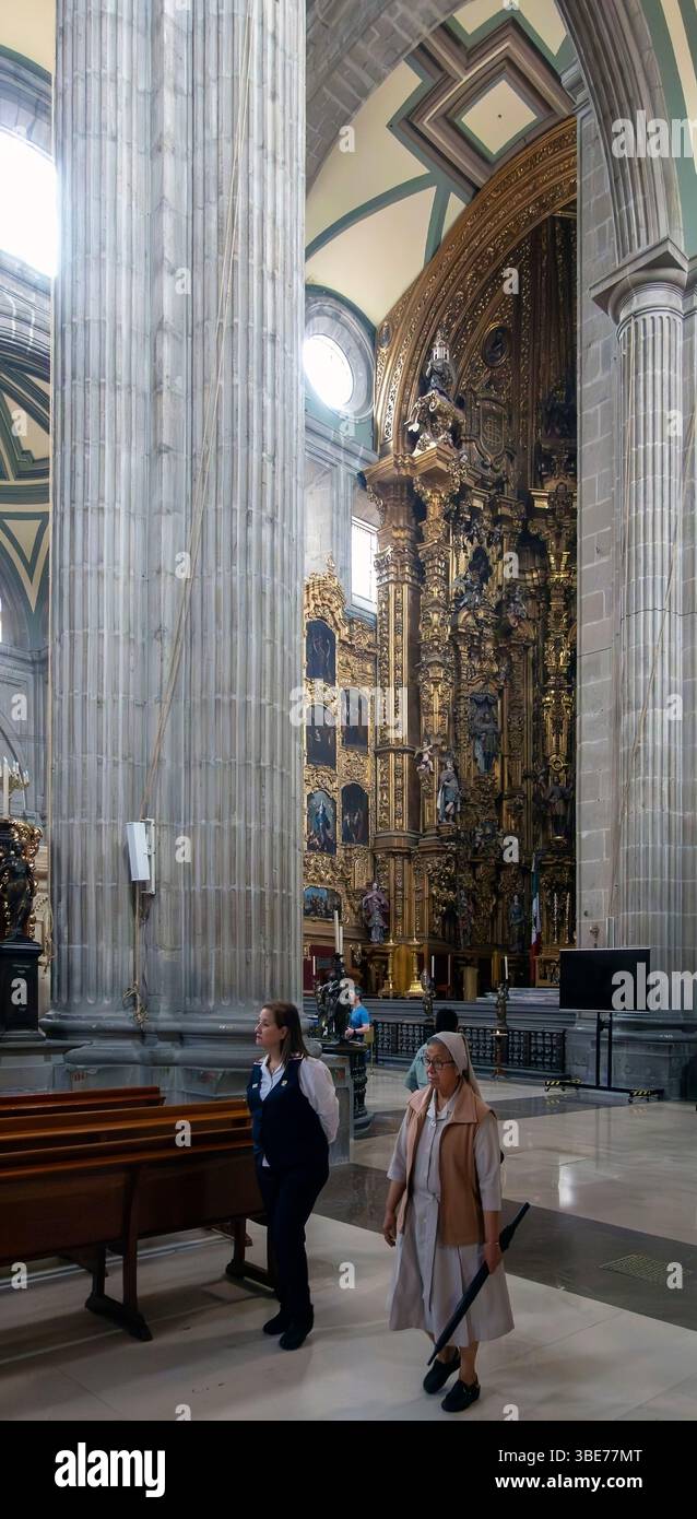 Nun and guide walk in the interior of the Metropolitan Cathedral ...