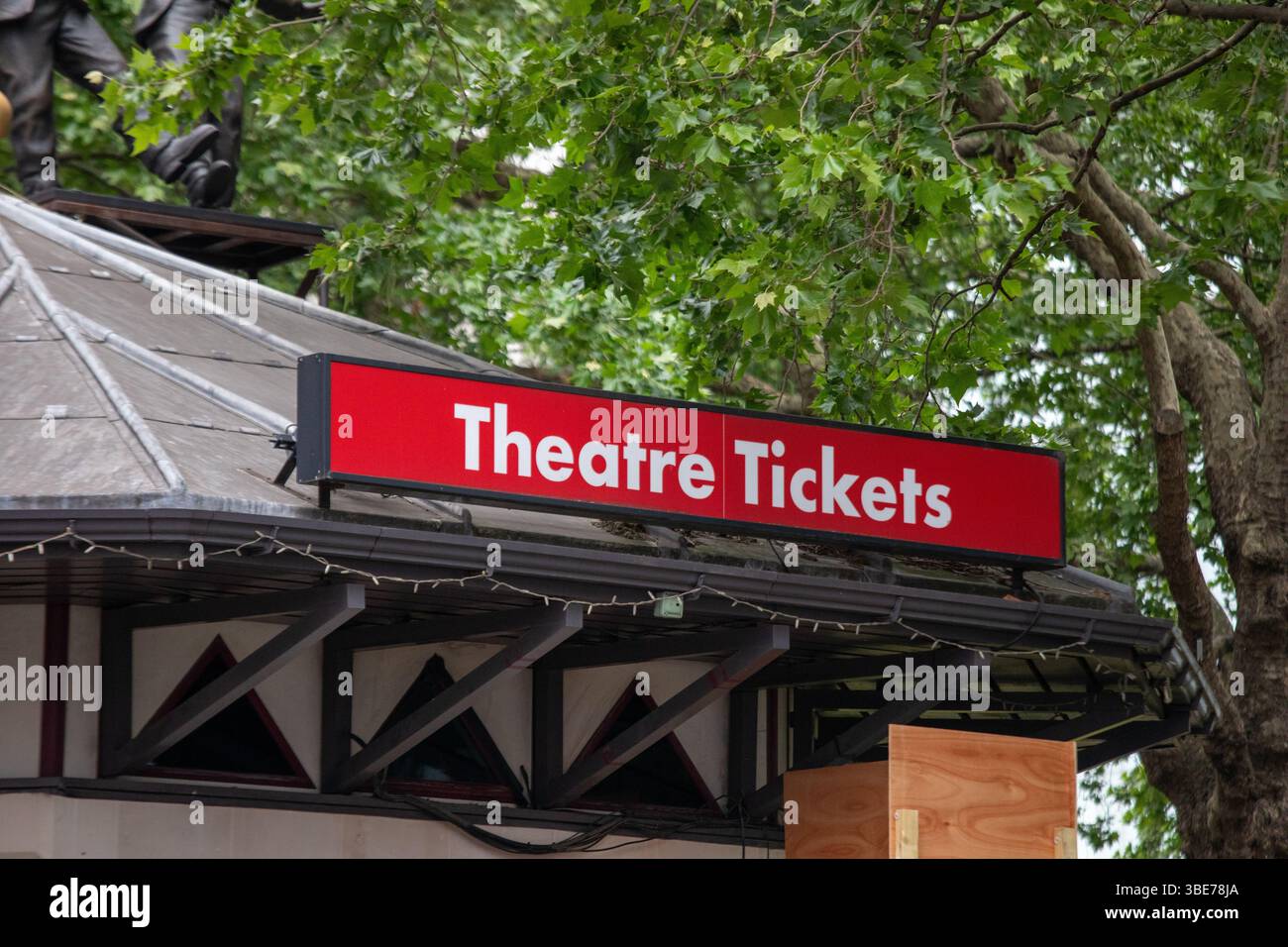 A red 'Theatre Tickets' sign displayed outside in London surrounded by ...