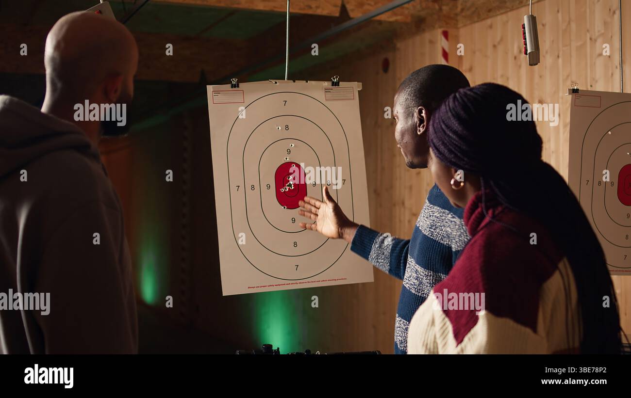 Shooting gallery safety officer explaining bullseye scoring system and ...