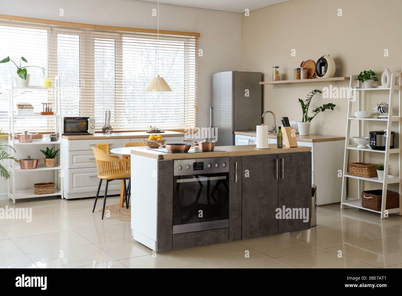 Interior of kitchen with counters, shelf units and dining table Stock ...