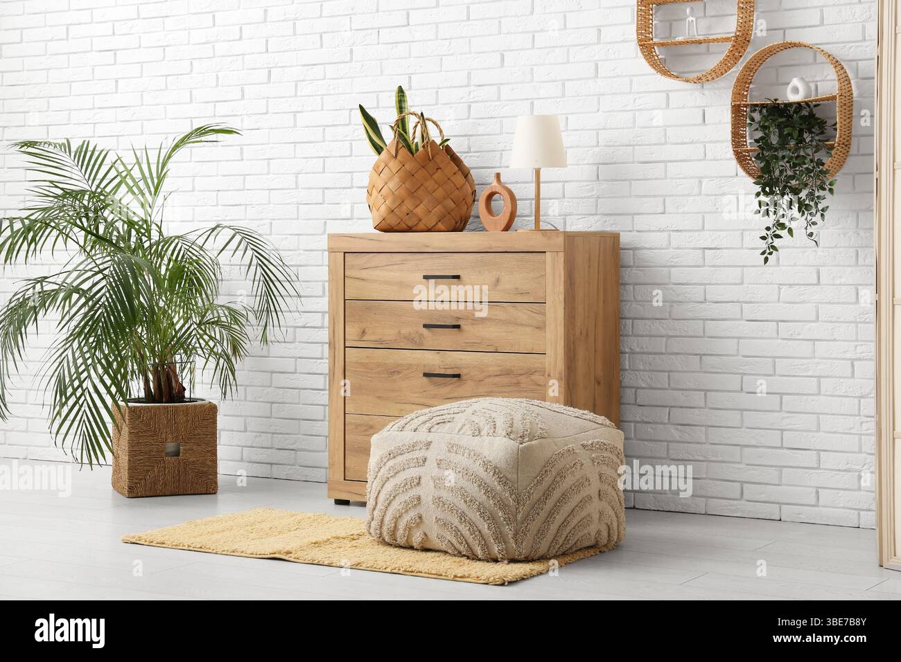 Interior of room with commode, shelves and plants in wicker baskets ...