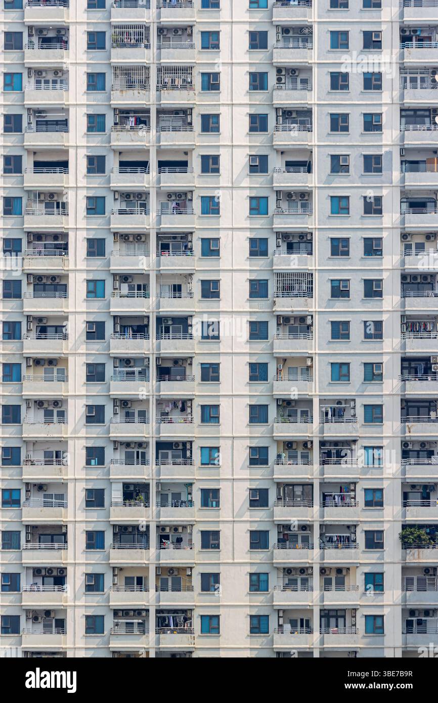 A high-rise residential building facade featuring multiple balconies ...