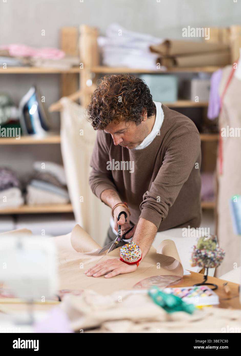 Man tailor cuts paper dress pattern and work with hand snip Stock Photo ...