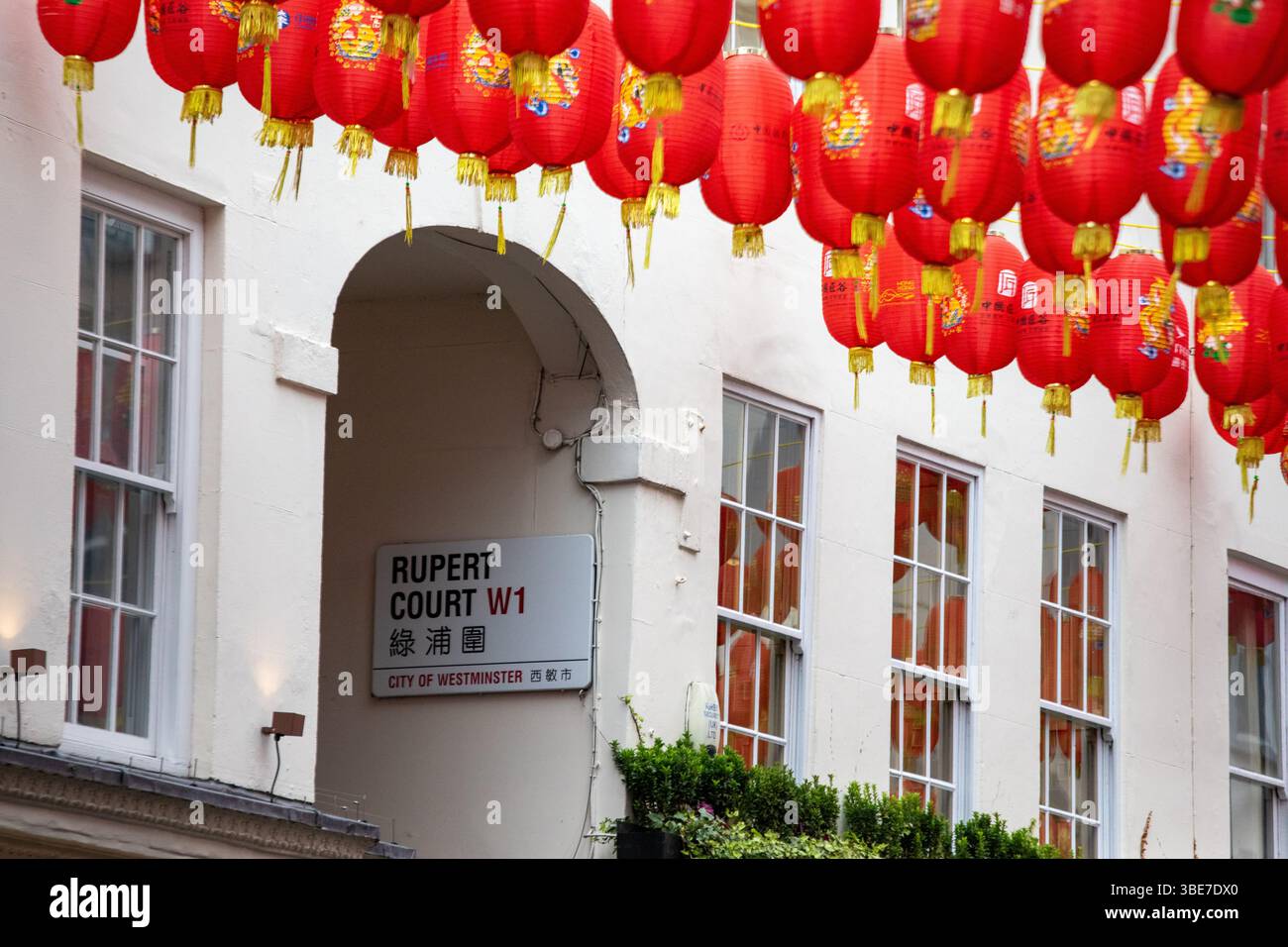 Red lanterns hang above Rupert Court in Londons Chinatown, adding ...
