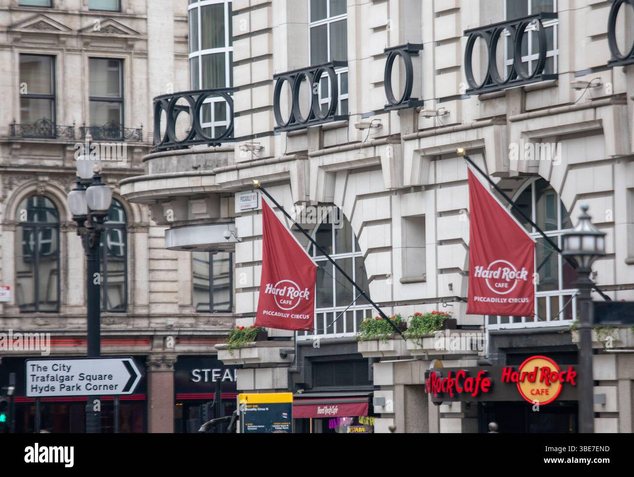 View of Hard Rock Cafe flags and signage at Piccadilly Circus in London ...