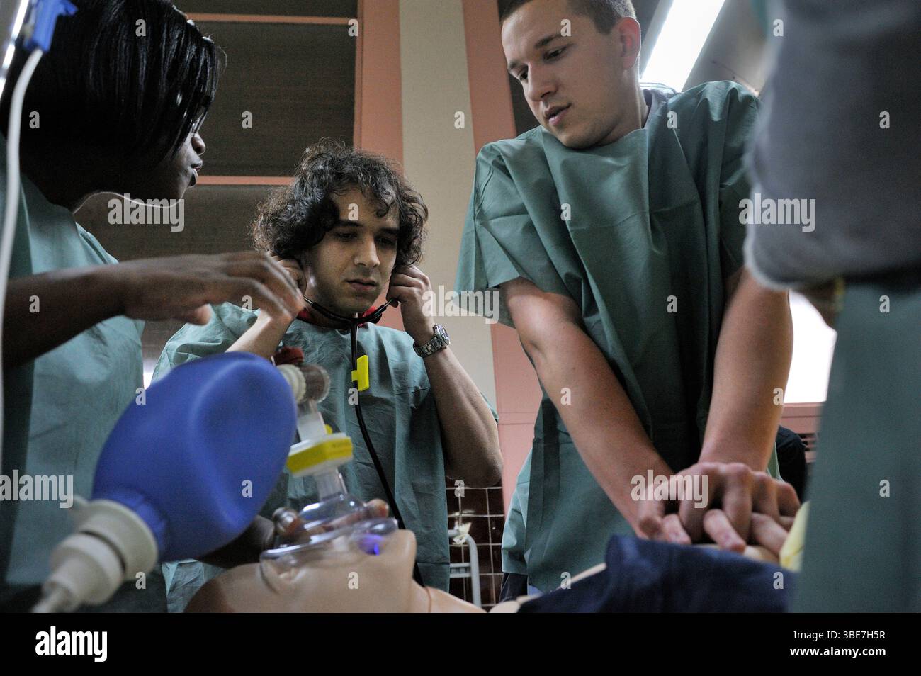 Student nurses undergoing cardiopulmonary resuscitation training with a ...