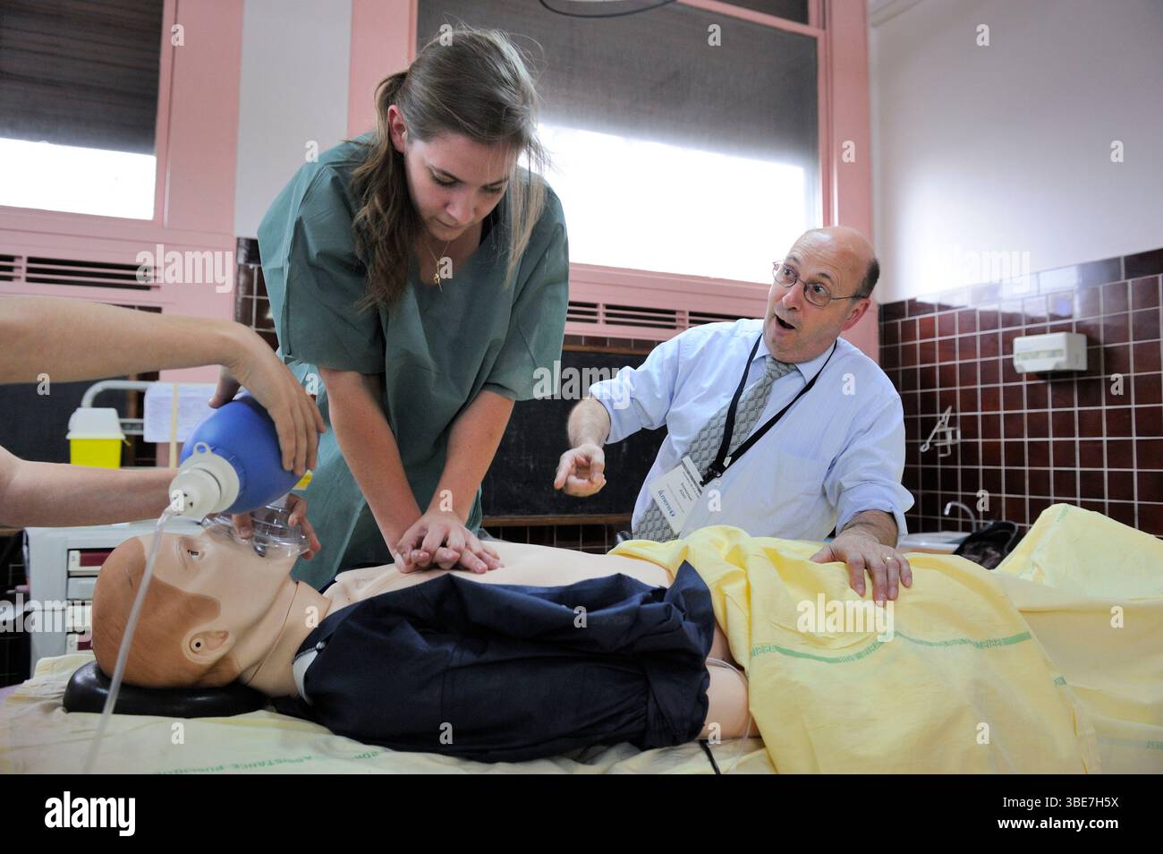 Student nurses undergoing cardiopulmonary resuscitation training with a ...