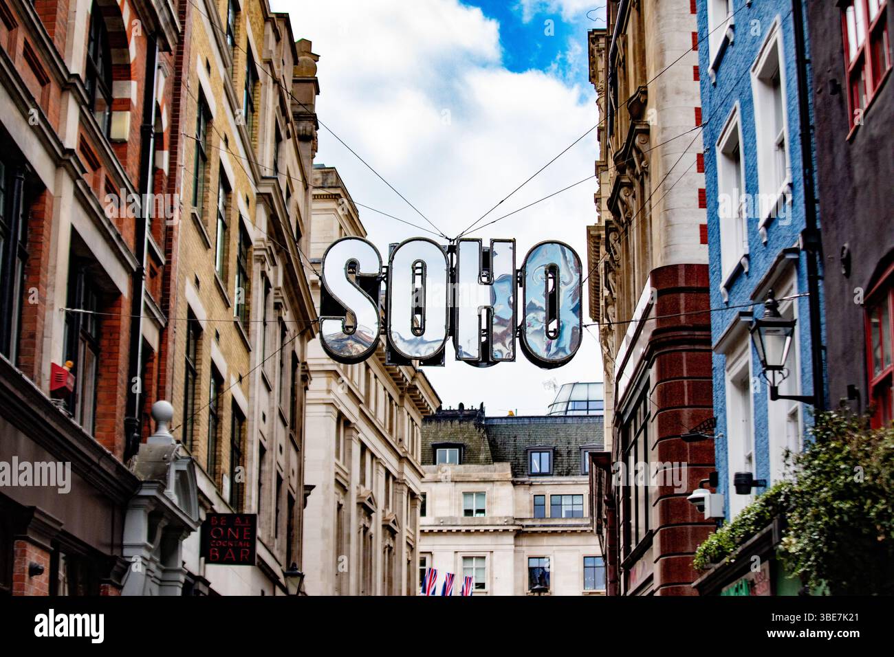 A vibrant street scene featuring a distinctive Soho sign in London. The ...