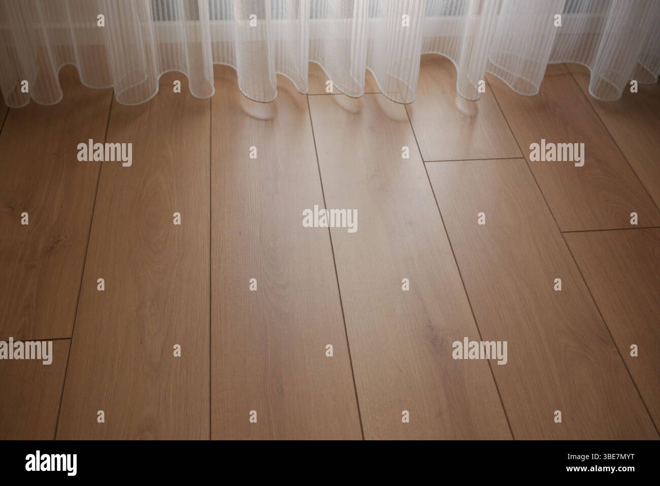 Light wooden floor under sheer white curtains Stock Photo - Alamy