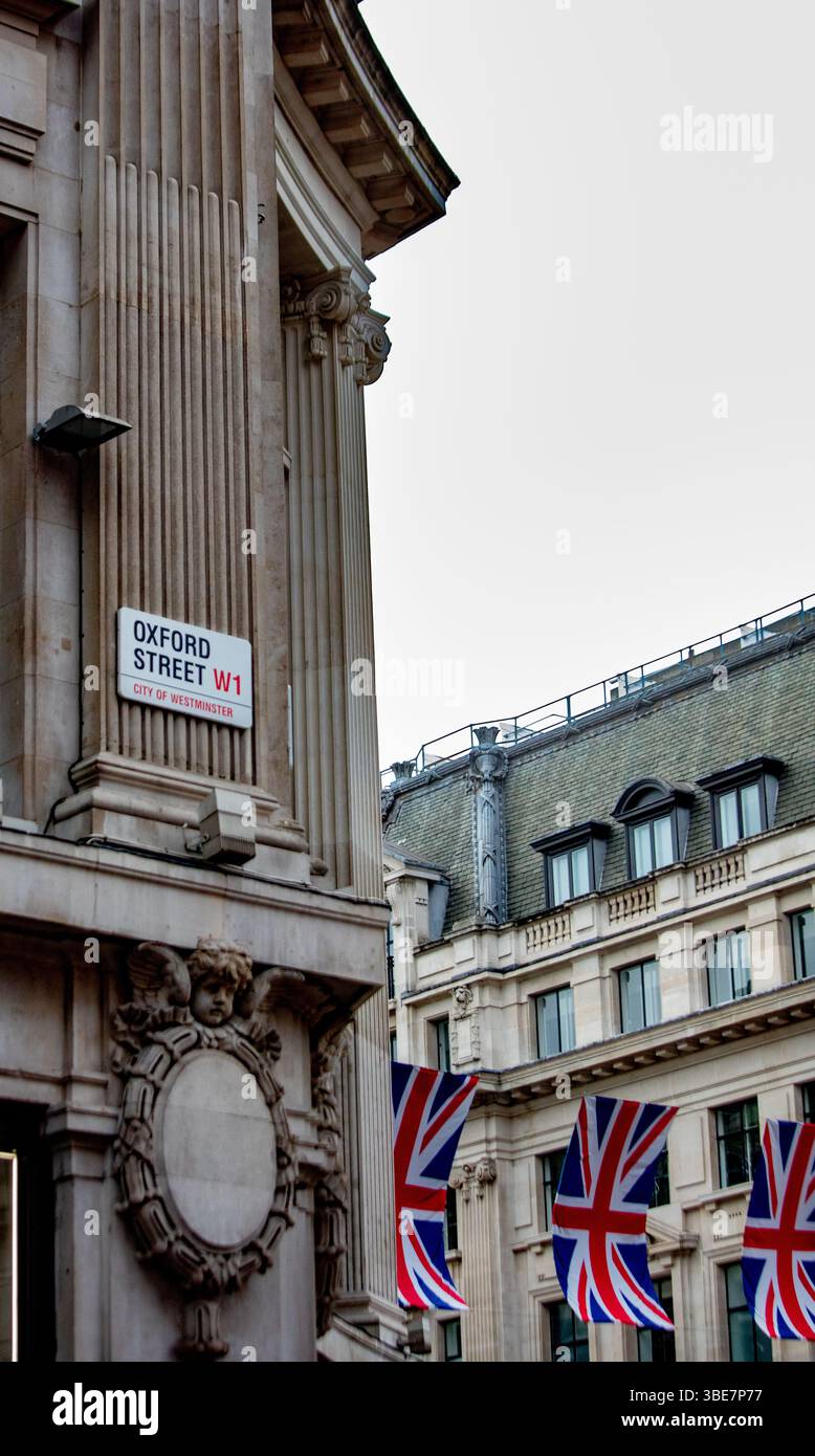 Classic architecture on Oxford Street in London with Union Jack flags ...