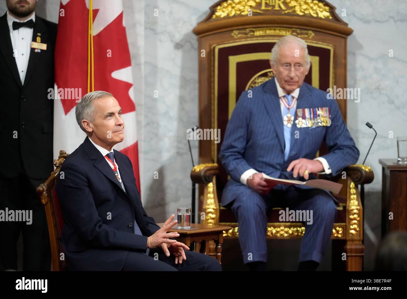 Prime Minister Mark Carney, left, gestures ahead of King Charles ...