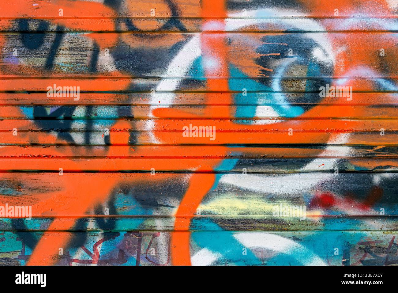 colorful graffiti on worn and weathered textured metal wall. modern ...