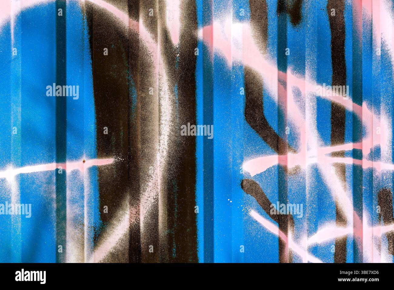 corrugated metal fence covered by abstract graffiti. contemporary urban ...