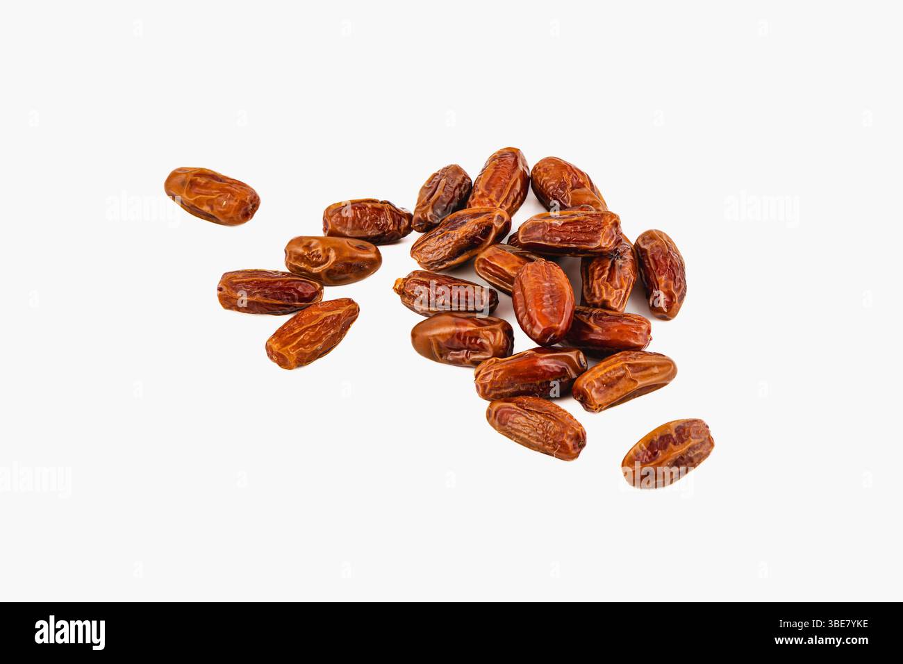 A collection of dried fruits laid out on a clean white background ...