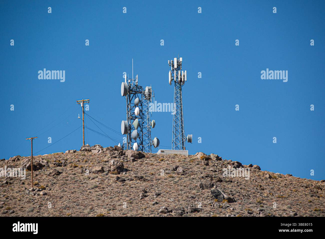 Communications microwave and cellular towers on top of a high hill ...