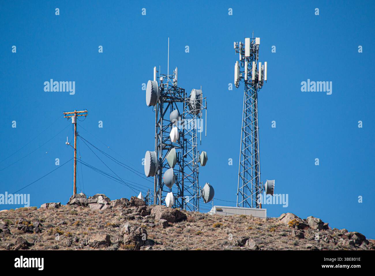 Communications microwave and cellular towers on top of a high hill ...